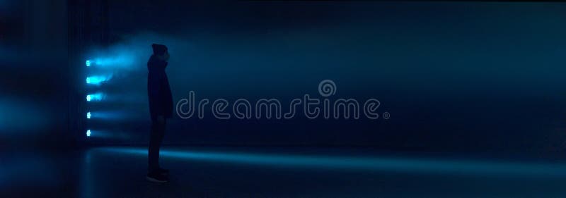 Man in Protective Mask Stand in Neon Light Garage. Stock Photo - Image ...