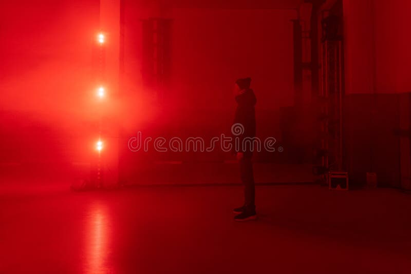 Man in Protective Mask Stand in Neon Light Garage. Stock Image - Image ...