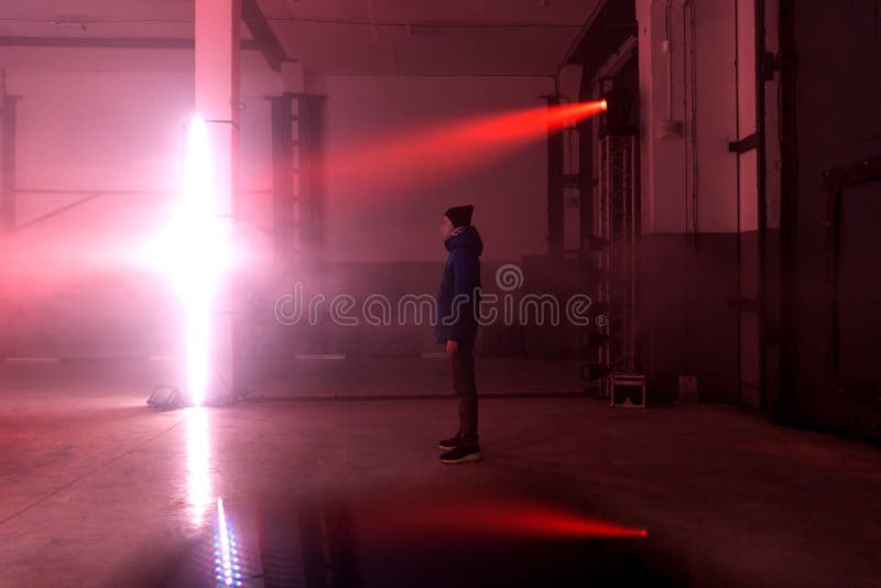 Man in Protective Mask Stand in Neon Light Garage. Stock Photo - Image ...