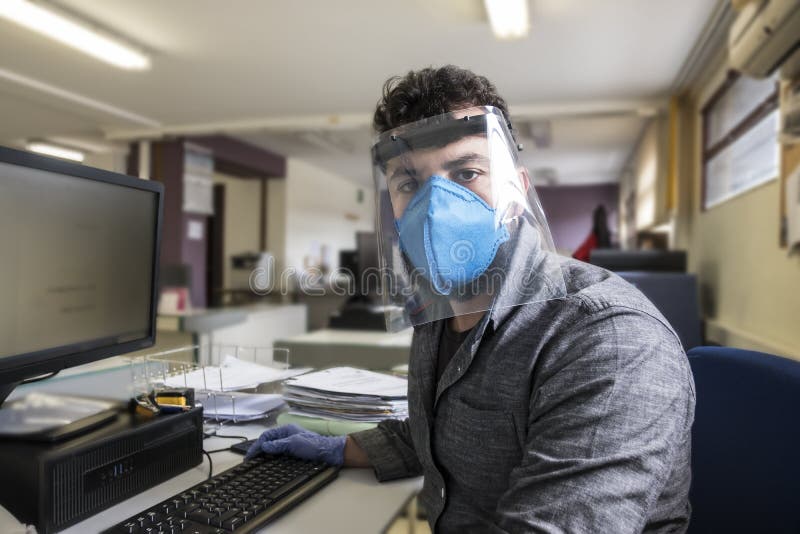 Man with Protective Screen and Facial Mask Working at Office Stock ...