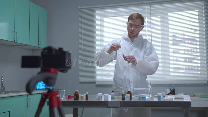 Man in Protective Workwear Show His Work on Camera in the Laboratory ...