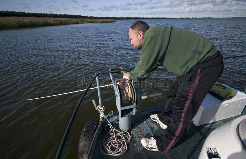 Man pulling anchor rope stock image. Image of water, strong - 6346289