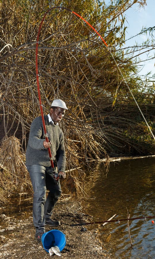 Man and Pulling Fish Near River Stock Image - Image of fisherman ...