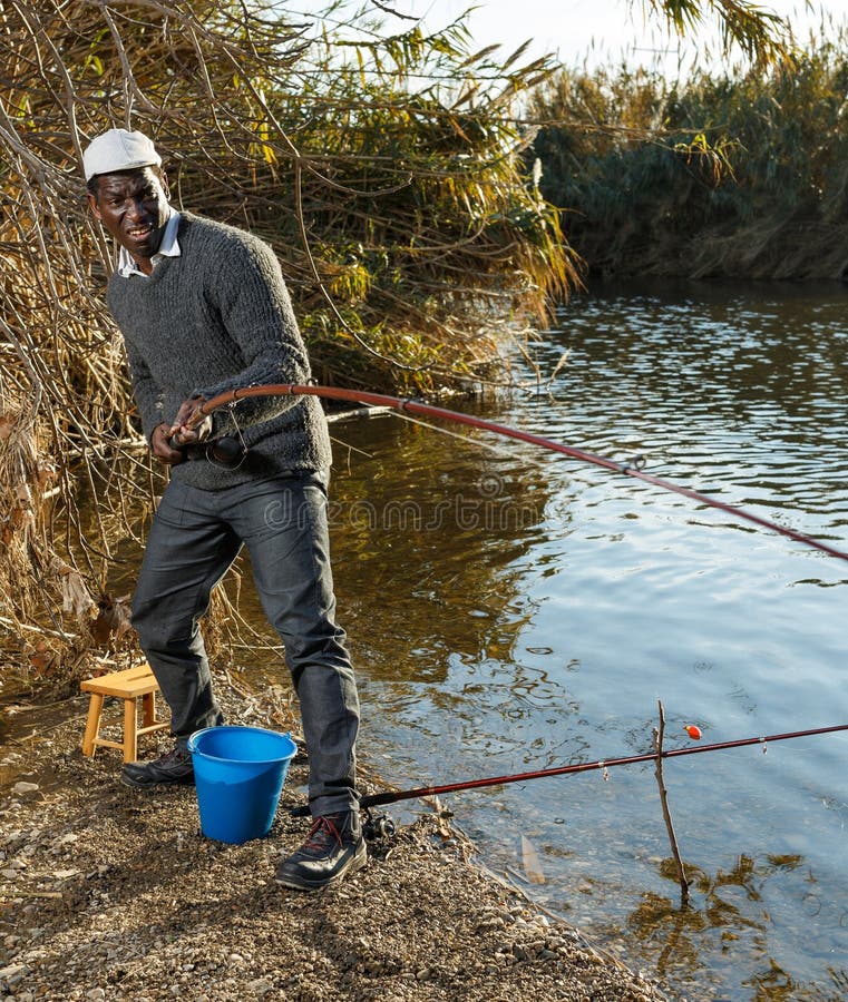 Man and Pulling Fish Near River Stock Image - Image of angler, holiday ...