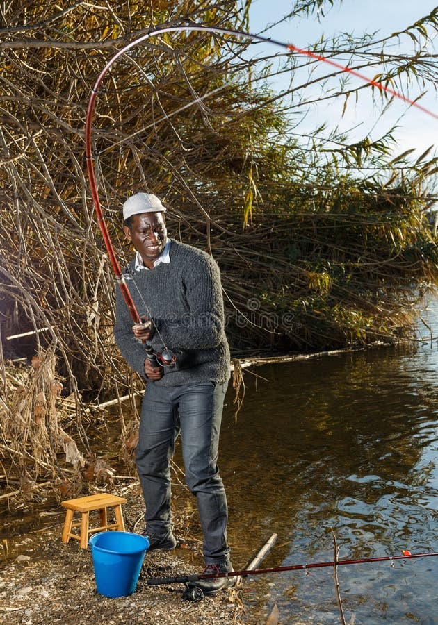 Man and Pulling Fish Near River Stock Photo - Image of lifestyle, bait ...