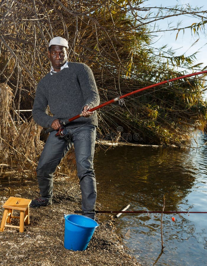 Man and Pulling Fish Near River Stock Image - Image of hobby, river ...