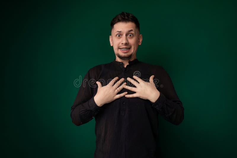 Man Pulling Funny Face in Front of Green Background Stock Image - Image ...