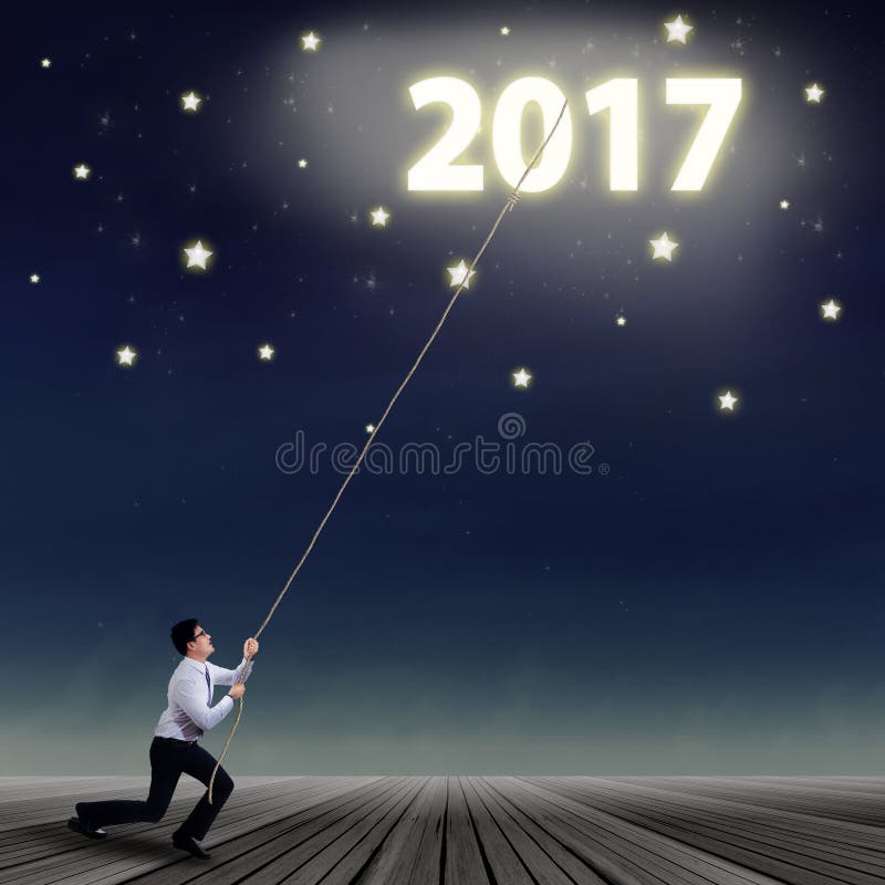 Man Pulling Number 2017 from the Sky Stock Image - Image of hispanic ...