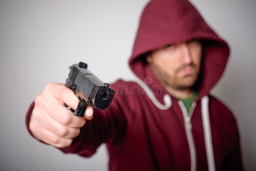 Man pulling out a gun stock image. Image of hand, firearm - 84211141