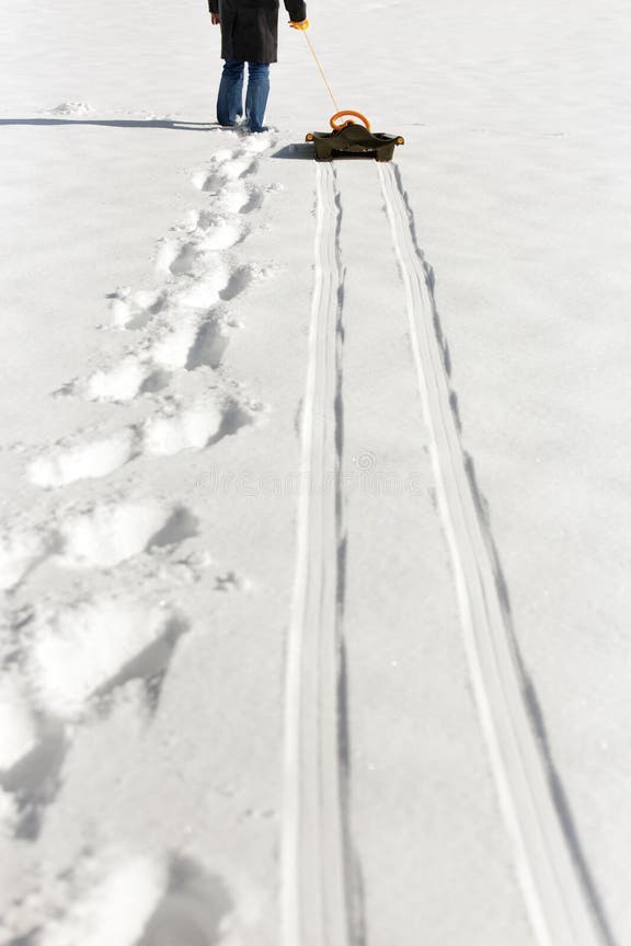 Man Pulling a Sledge in the Deep Snow, Footprints and Tracks Stock ...