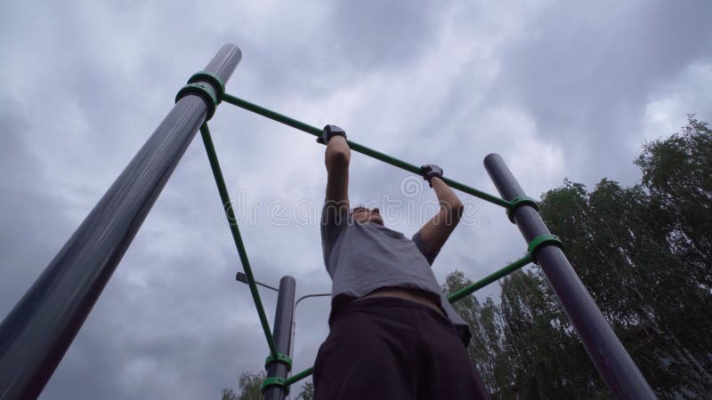 The Man Pulls Himself Up on the Bar. Playing Sports in the Fresh Air ... The Man Pulls Himself Up on the Bar. Playing Sports in the Fresh Air ...