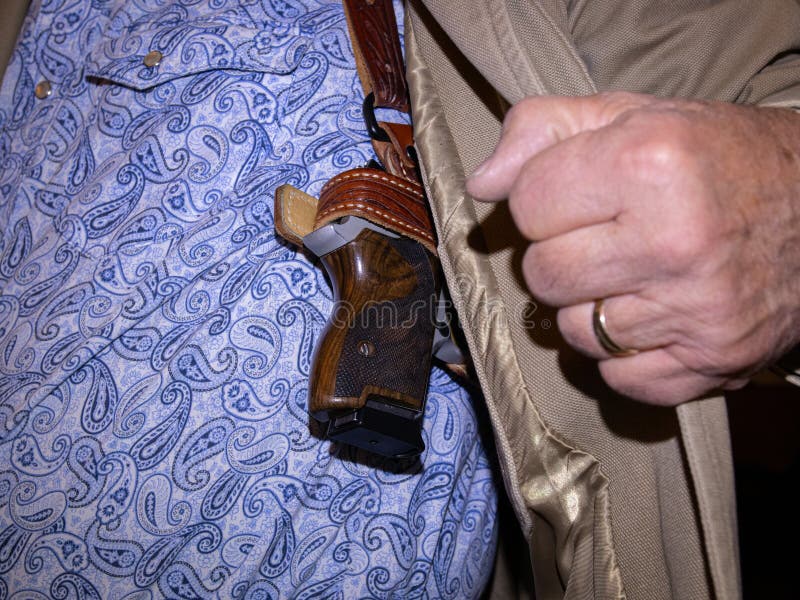 A Man Shows a Pistol in a Shoulder Holster Under His Coat Stock Image ...