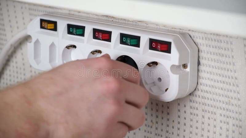 The Man Pulls the Plug Out of the Adapter Socket and Turns Off Switch ...