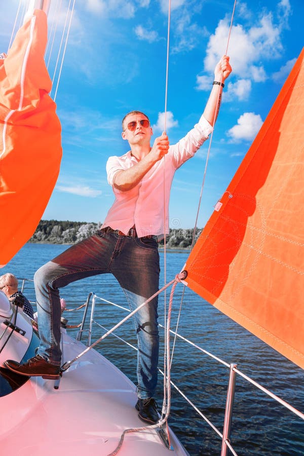 Man Pulls Sails on a Boat. Vertical Photo Stock Image - Image of ...