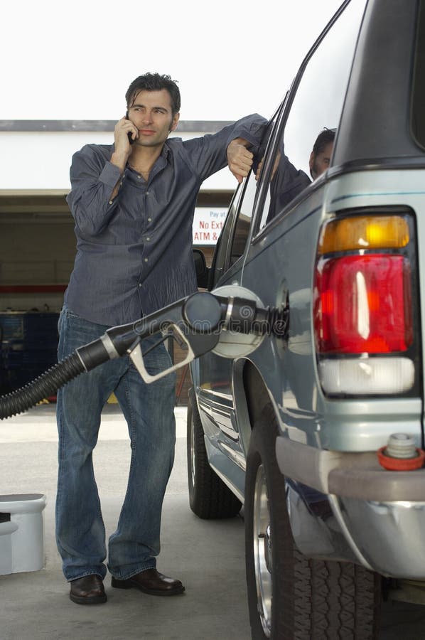 Man Pumping Gas into Car stock photo. Image of caucasian - 29658030