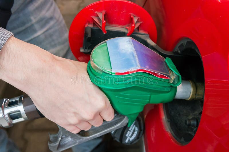 Man is Pumping Gas in Red Car in Fuel Station. Stock Image - Image of ...