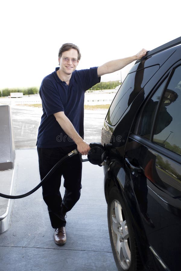 Man pumping gasoline stock image. Image of standing, smiling - 18583743