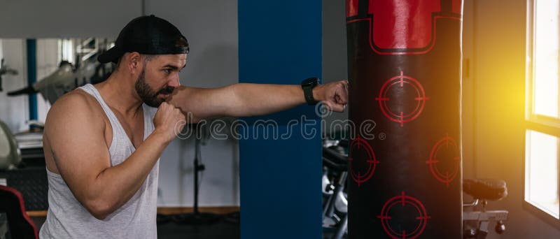 Man Punching Punching Bag in Gym. Gym Stock Photo - Image of boxing ...
