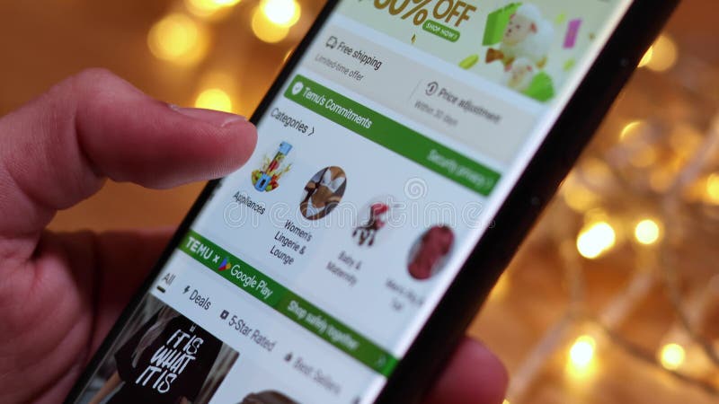 A Man Purchasing Online through an App Scrolling on a Mobile Device ...