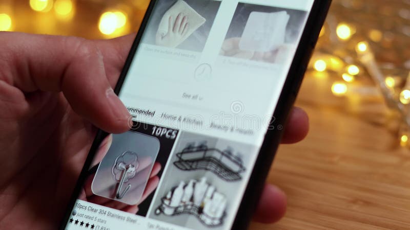 A Man Purchasing Online through an App Scrolling on a Mobile Device ...