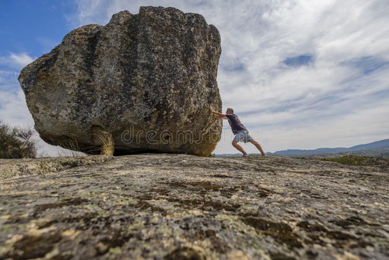 Man pushing a big stone stock image. Image of blue, brave - 104197441 Man pushing a big stone stock image. Image of blue, brave - 104197441