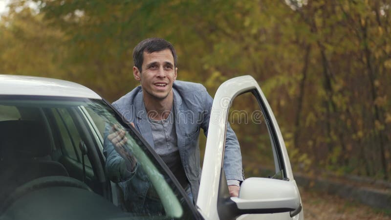 Man pushing a broken car stock video. Video of move - 237723209