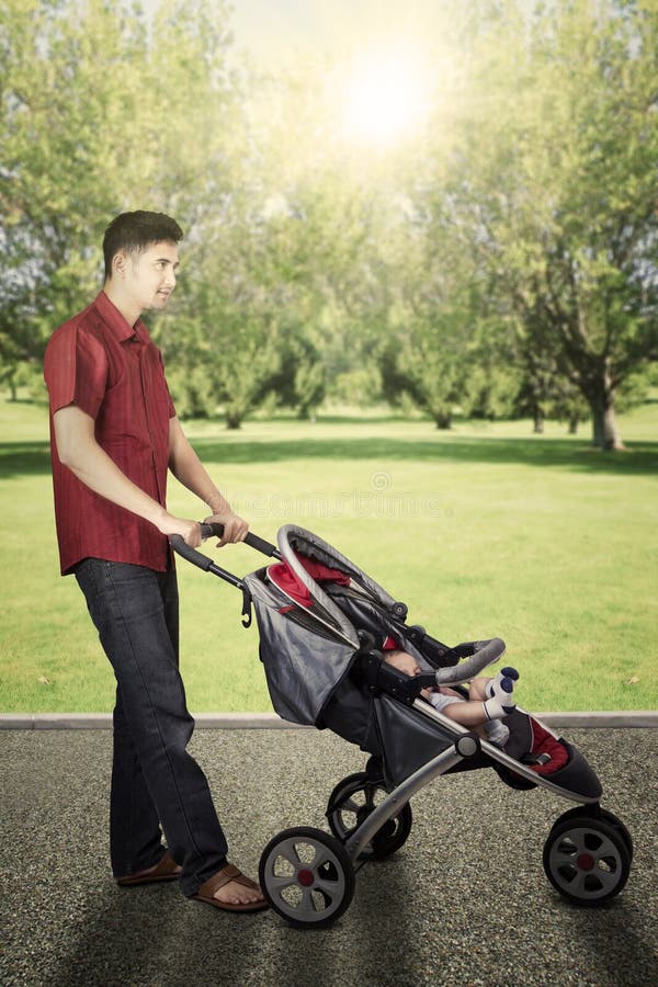 Man Pushing Perambulator at the Park Stock Image - Image of outdoors ...