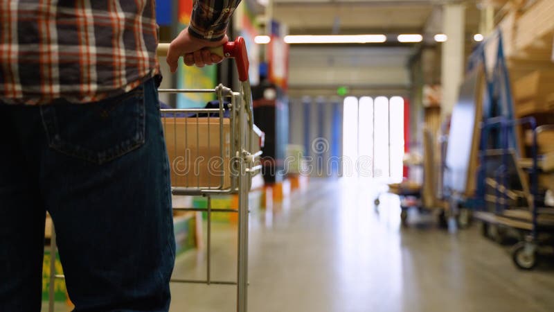 A Man Pushing Trolley on Escalator in Hardware Store Stock Footage ...