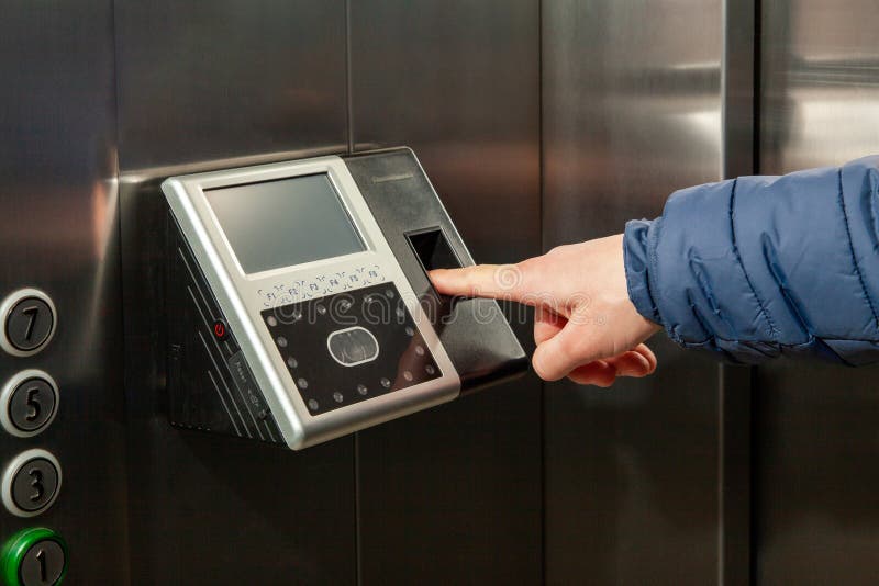 The Man Put His Finger in the Fingerprint Access Control Terminal with Face Recognition Function ...