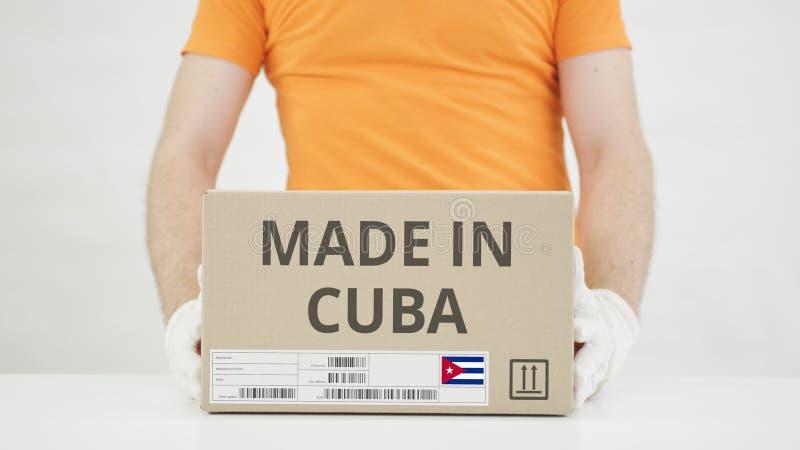Man Puts Cardboard Box with MADE in CUBA Text on the Table Stock Image ...