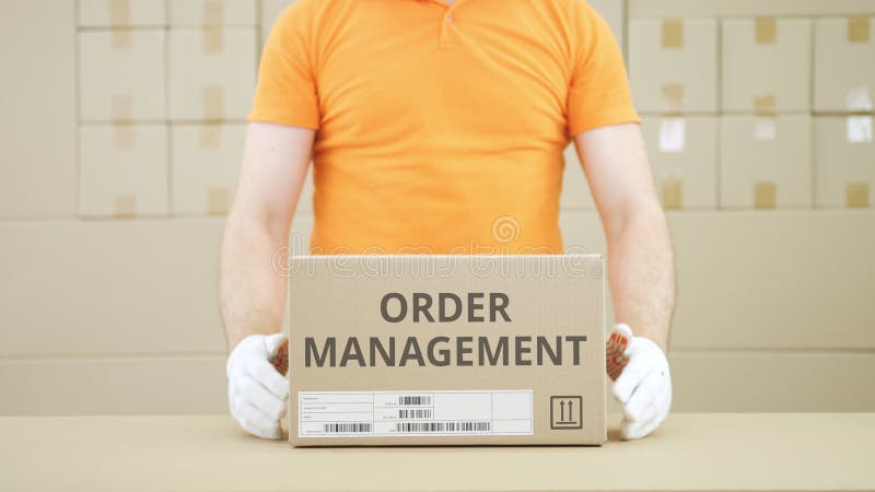 Man Puts Carton with ORDER MANAGEMENT Text on the Table Stock Image ...