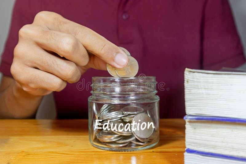 A Man Puts Coins into a Glass Jar for Education Fund. Saving Money for ...