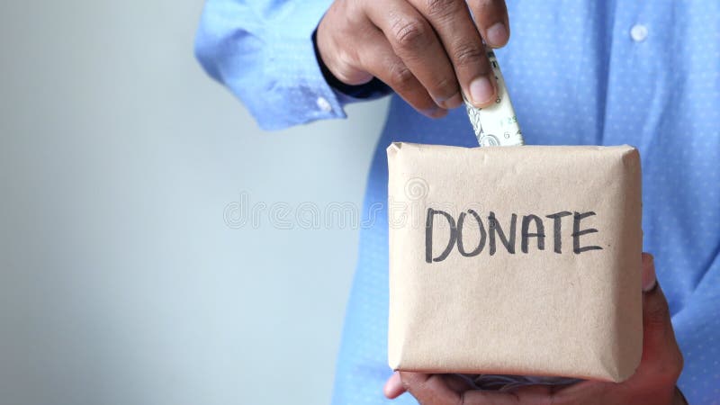 Man Puts Donation in a Box with Copy Space . Stock Video - Video of ...