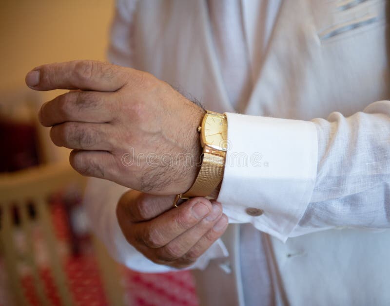 Man Puts a Gold Watch on His Hand. Stock Photo - Image of blouse, late ...