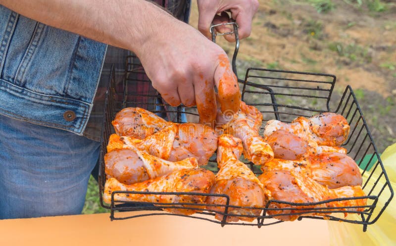 The Man Puts on the Grill for Frying Chicken. Stock Image - Image of ...