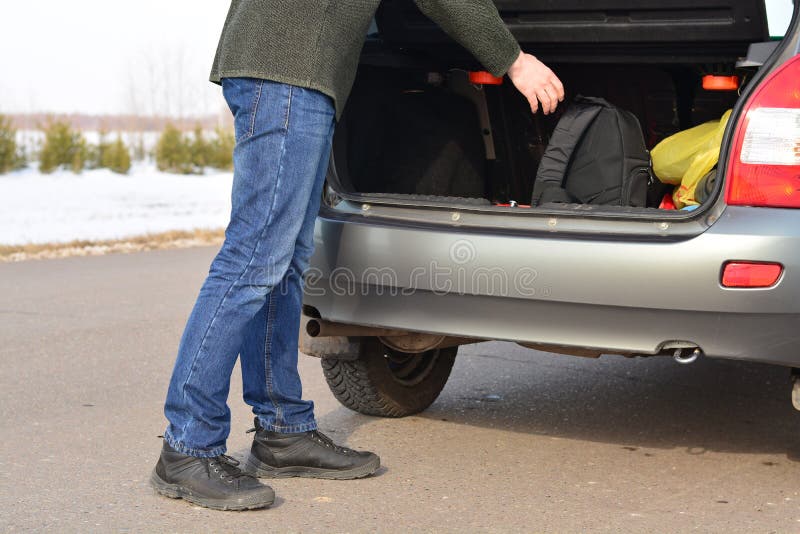 The Man Puts His Backpack in the Car Stock Photo - Image of meadow ...