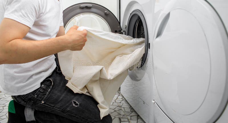 Man Puts Laundry in an Automatic Washing Machine Stock Photo - Image of ...