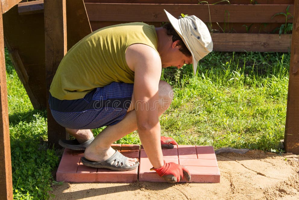 Man Puts Red Concrete Paving Slabs Stock Photo - Image of paving ...