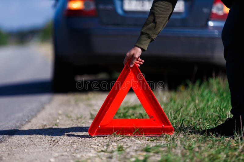 Man Puts Red Warning Triangle Stock Photo - Image of move, land: 93264432