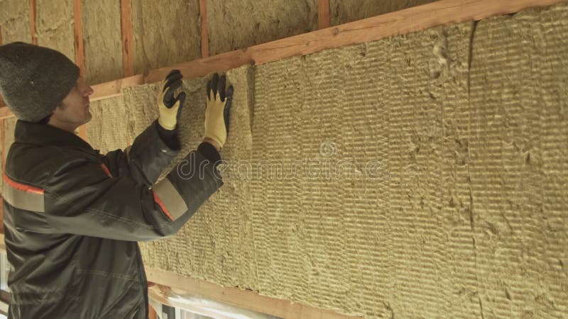 Man Laying Insulation in a Wall Stock Video - Video of insulating, male ...