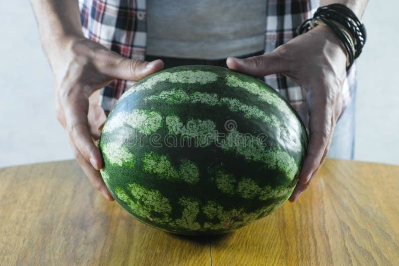 Man Puts a Watermelon on the Kitchen Table. Close-up Hands. Stock Image ...
