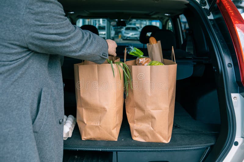 Man Putting Bags with Product in Car Trunk Stock Photo - Image of ...