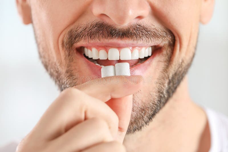 Man Putting Chewing Gums into Mouth on Blurred Background, Closeup ...