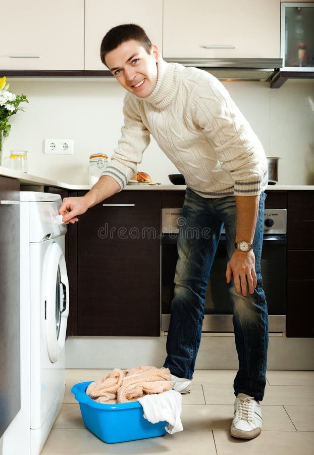 Man Putting Clothes into Washing Machine Stock Image - Image of machine ...