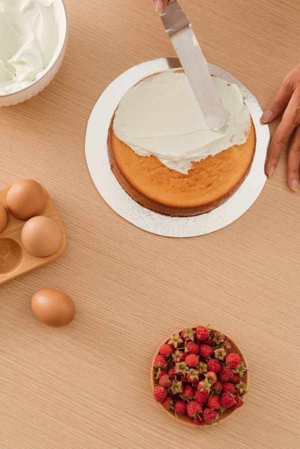 Man Putting Cream on Sponge Cake. Making Home-made Cake Process Stock ...