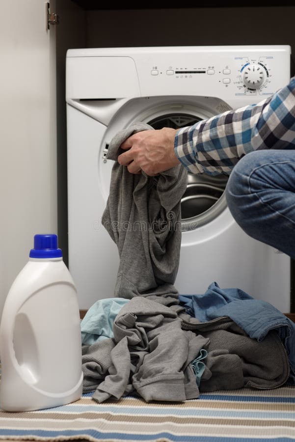 Man Putting Dirty Clothes into Washing Machine Stock Image - Image of ...