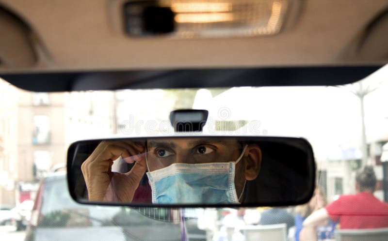 Man Putting on the Face Mask Inside the Car Stock Photo - Image of ...