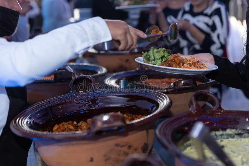 Man Putting a Food To a Plate in a Buffet of Mexican Food Stock Photo ...