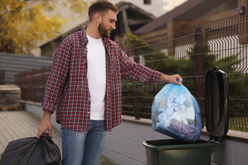 Man Putting Garbage Bag into Recycling Bin Outdoors Stock Image - Image ...