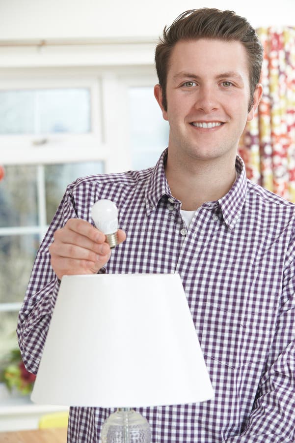 Man Putting Low Energy LED Lightbulb into Lamp at Home Stock Photo ...